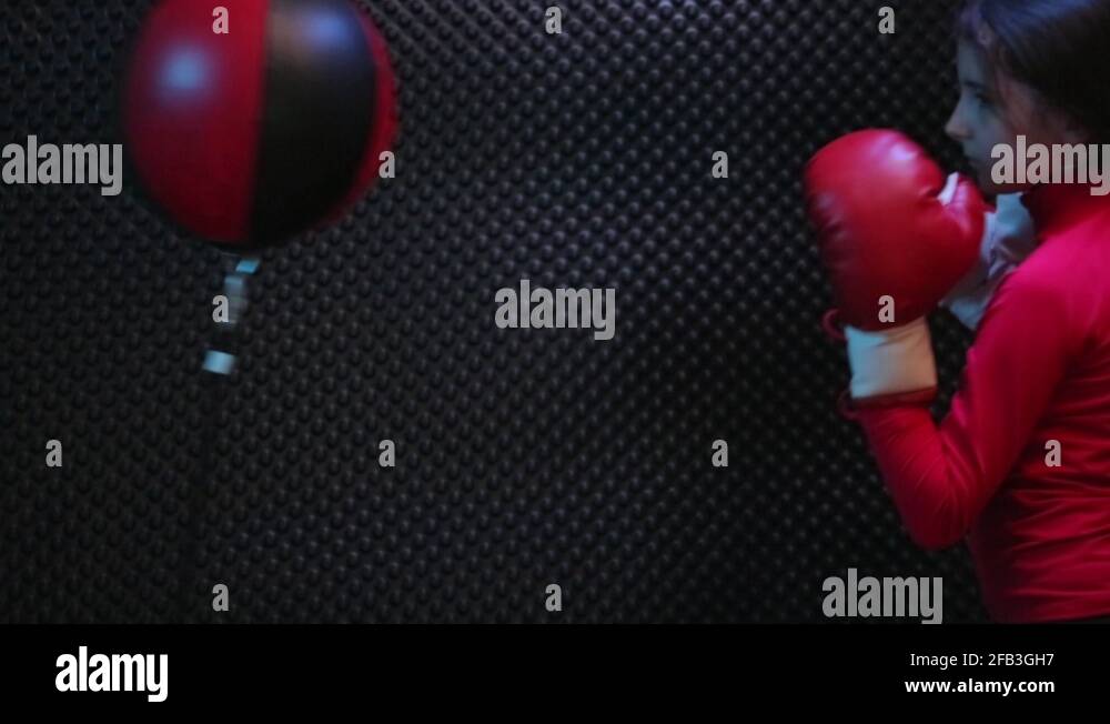 Little girl in red boxing gloves punching double end striking bag Stock ...