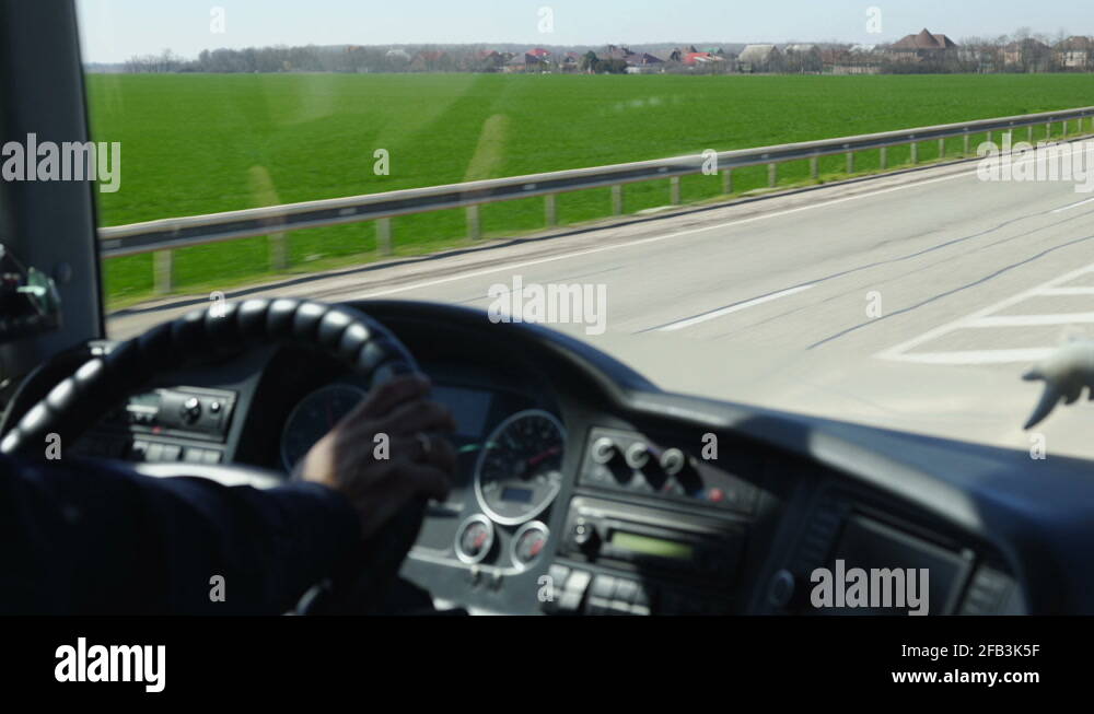 Bus driver behind the wheel of long-distance coach. Man driving ...