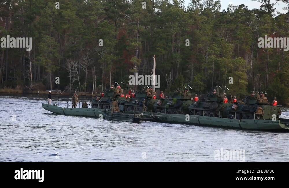 Soldiers travel on a barge loaded with amphibious vehicles - 2018 Stock ...