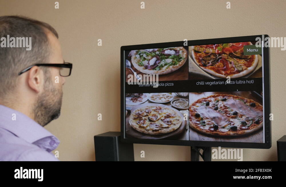 A man orders pizza online on a computer at home. A businessman makes an ...