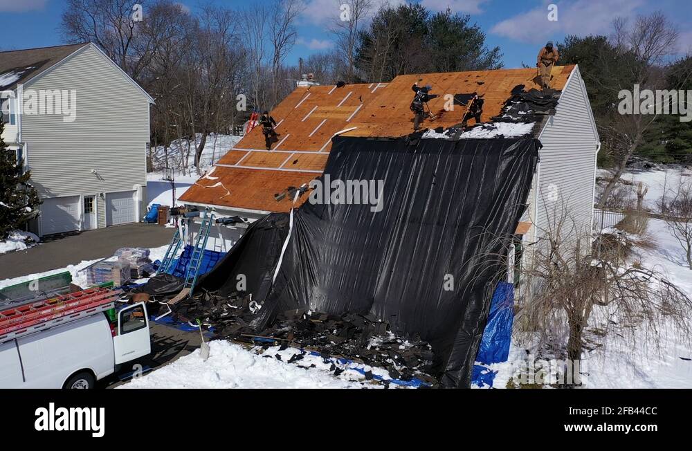 Construction Workers Tearing the Old Roof off of a Two Story Colonial ...