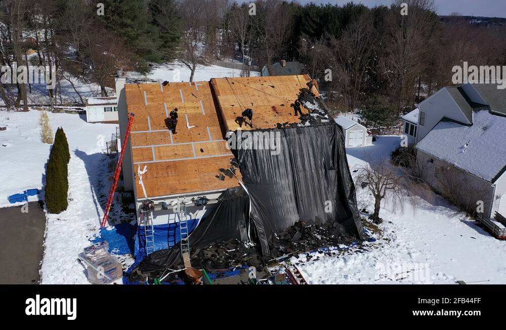 Construction Workers Tearing the Old Roof off of a Two Story Colonial ...