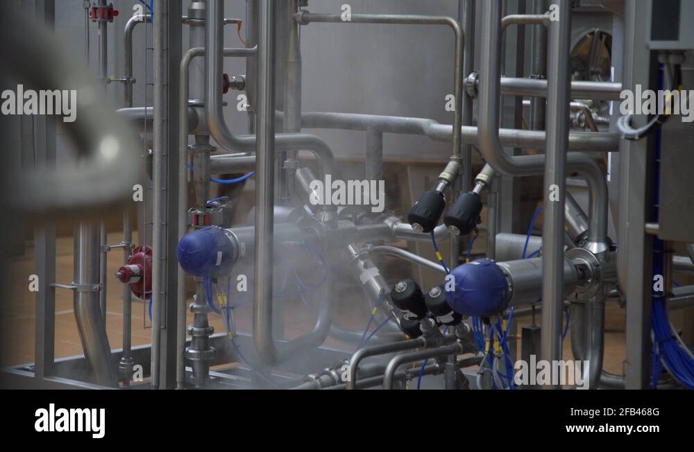 Stainless steel temperature control valves and pipes in modern dairy ...