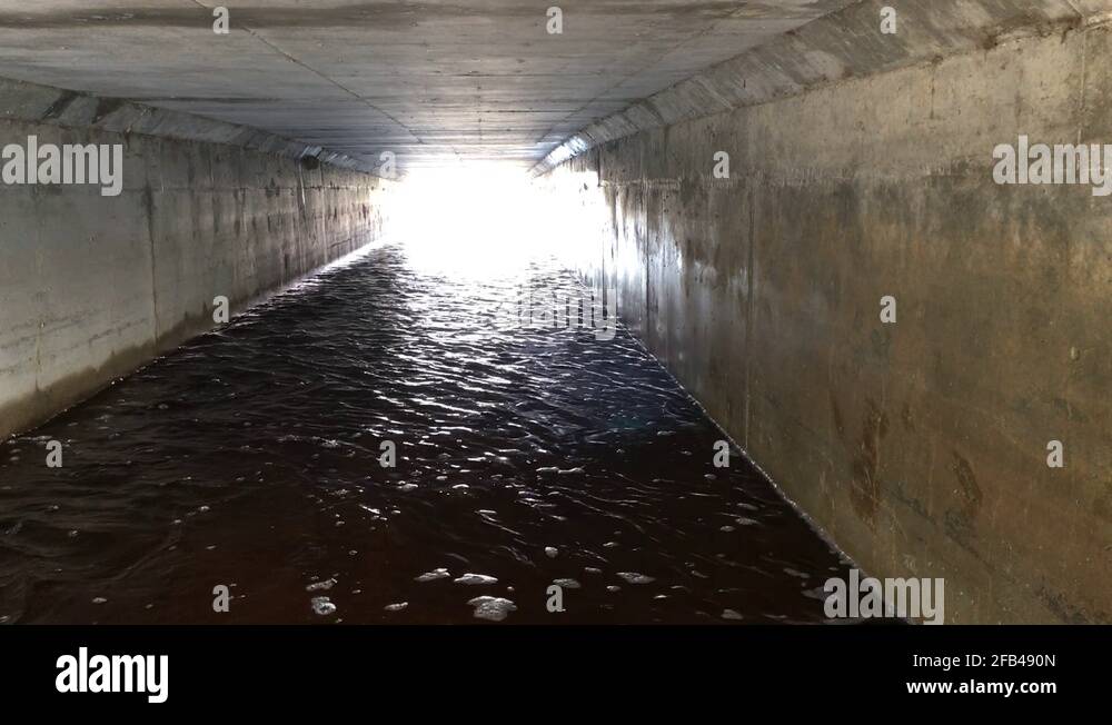 Spring water flow through concrete box culvert under highway Stock ...