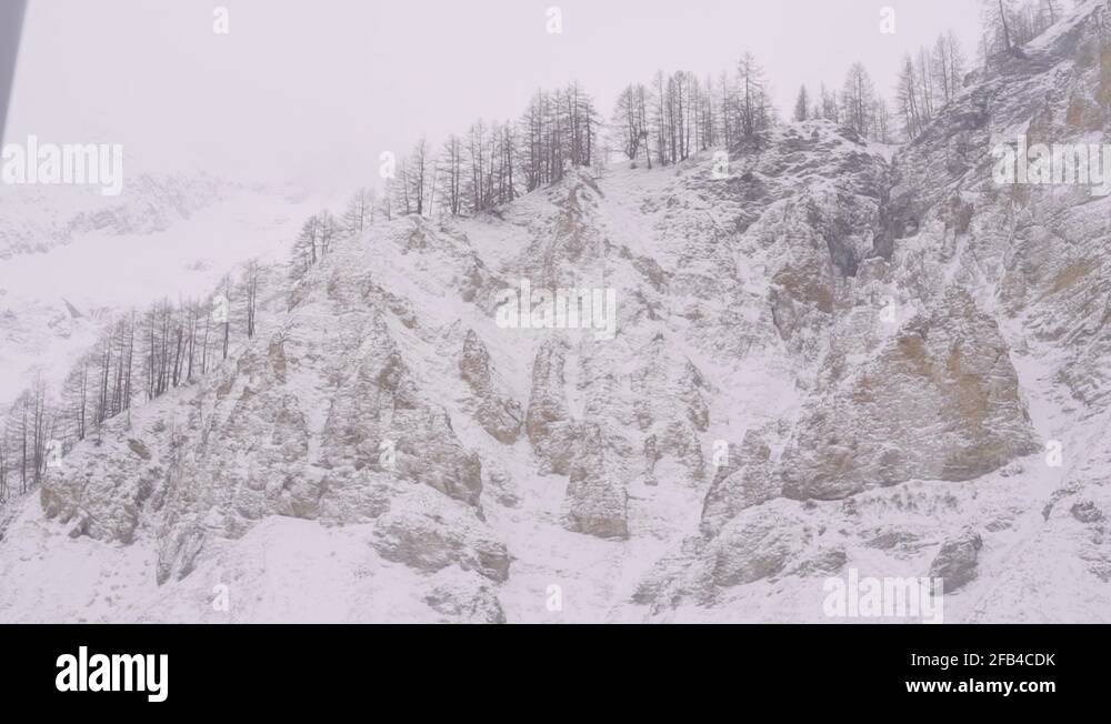 Panning camera view from cabin window of Skyway going up to Mont Blanc ...