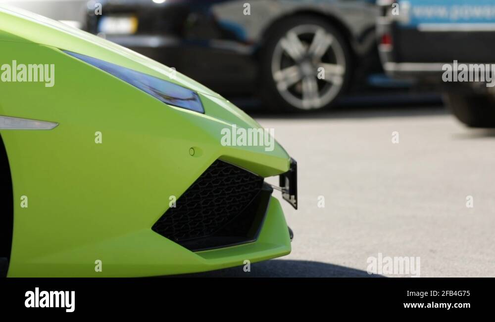 Close up of a front bumper and headlight of a green supercar lowered ...