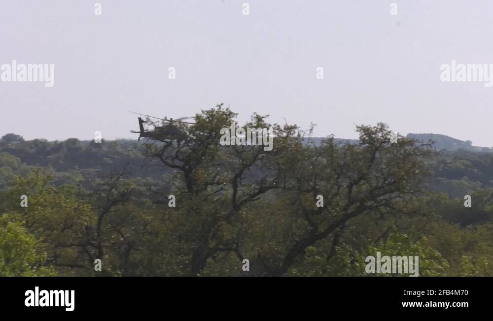New version of AH-64 Apache helicopter in flight above trees Stock ...