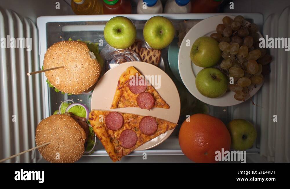 Flat lay of the hand take food at night with on the shelves of the ...