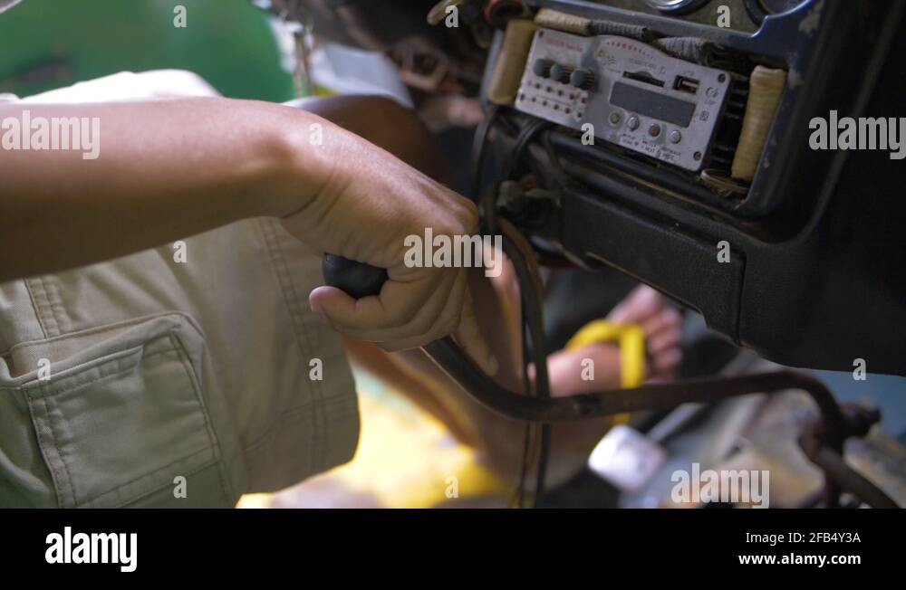Driver wearing shorts and flip flops shifts gears of a truck carrying ...