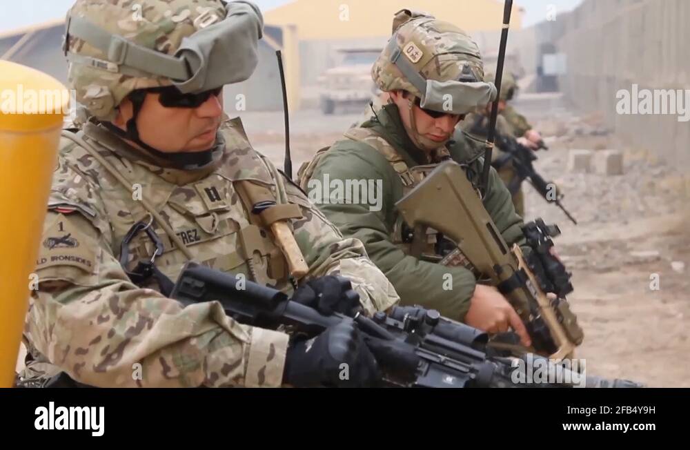 Australian soldiers inspecting rifle at Multi-National Base Command ...