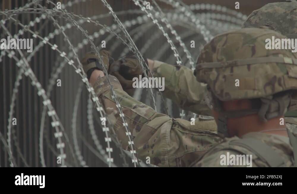 Soldiers installing concertina wire at Gateway International Bridge ...