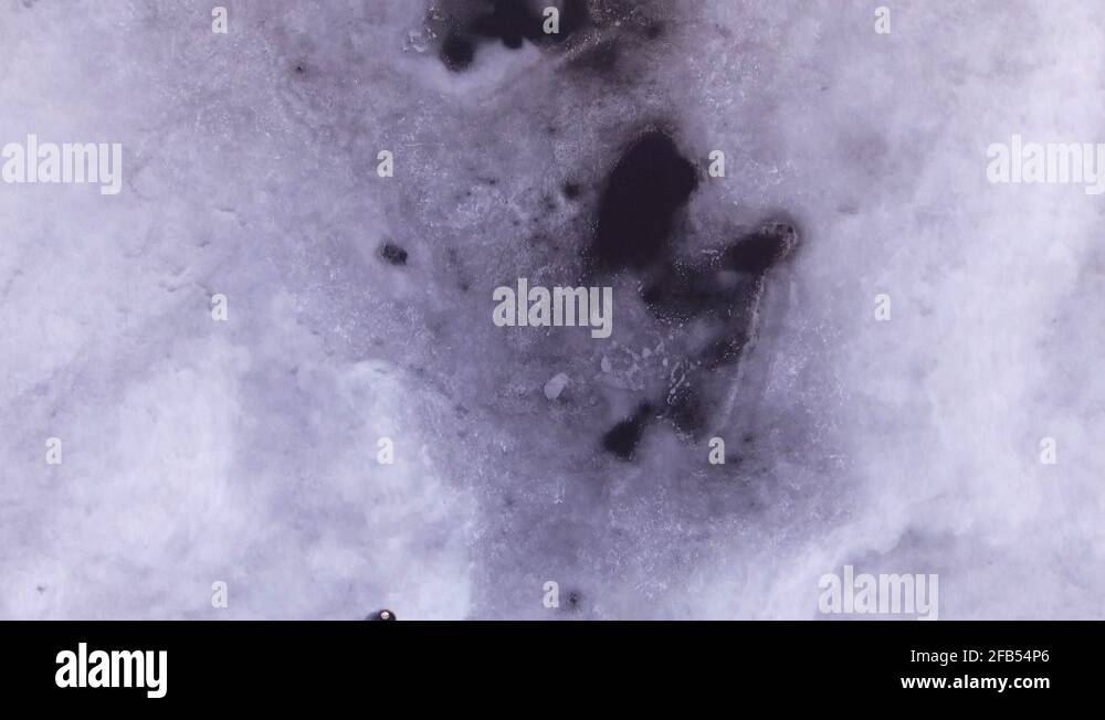 Birds eye view of a huge formation of lake currents melted holes in the ...
