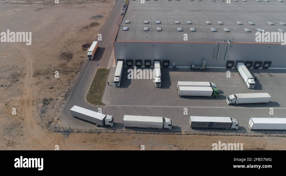 Buildings of logistics center, warehouses in field near the highway ...
