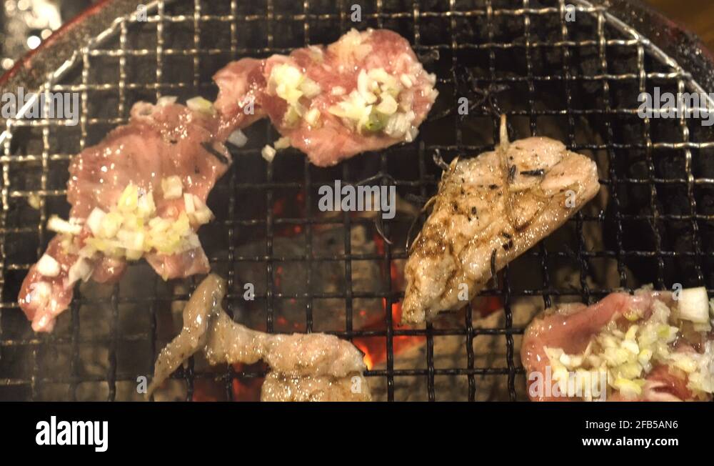 Japanese style beef tongue charcoal bbq grill top view Stock Video ...