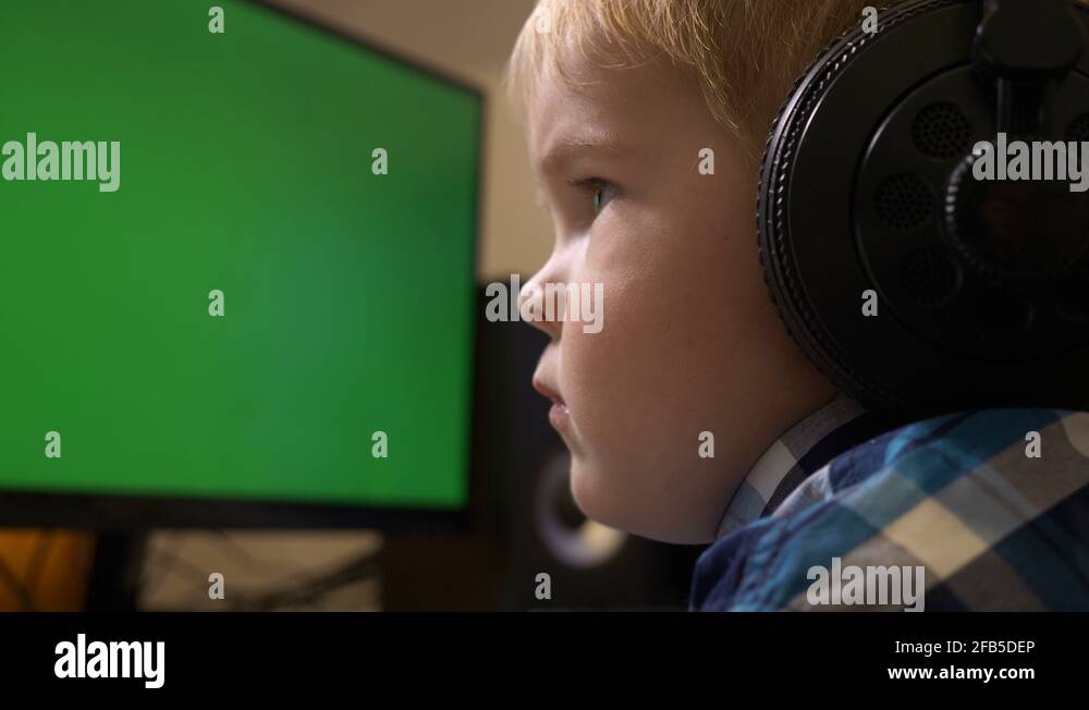 4K 60p Little Child Sits Watching in front of Green Screen Monitors ...