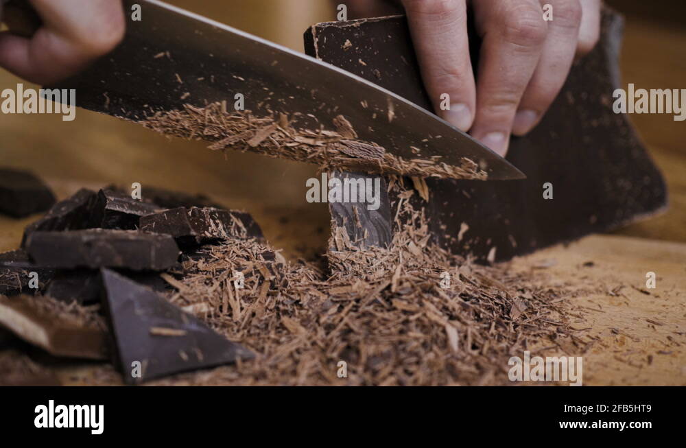Chopped dark chocolate on kitchen board. Chopping a Bar of Chocolate ...