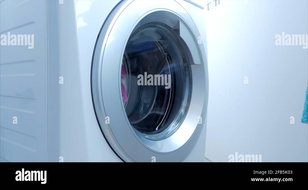 Cute Child Looks Inside the Washing Machine. Cylinder Spinning Machine ...