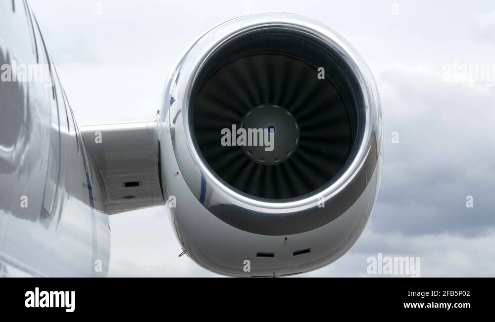 Close up regional airliner aircraft engine fan blades spinning down ...