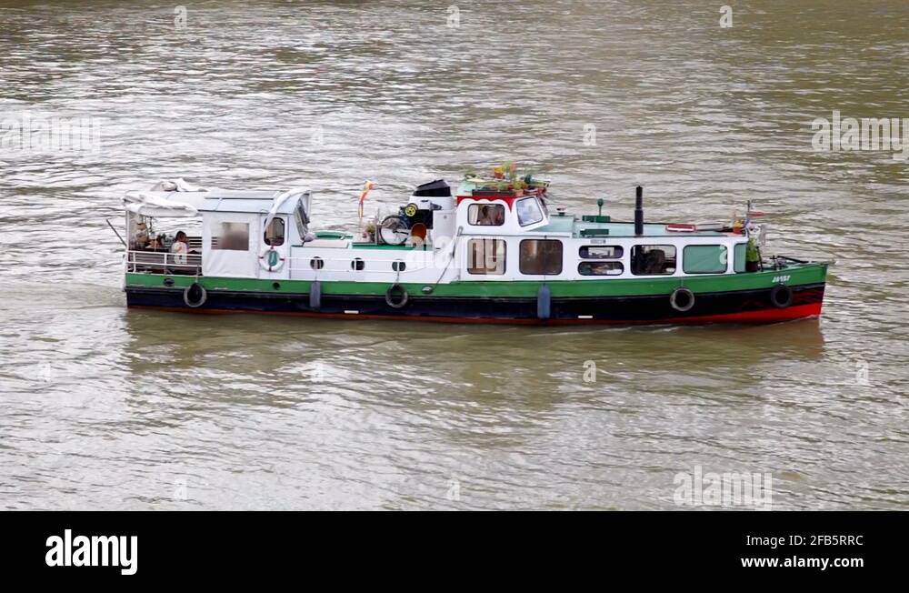 White peniche, iconic parisian boat, full of tourists, cruising on the ...