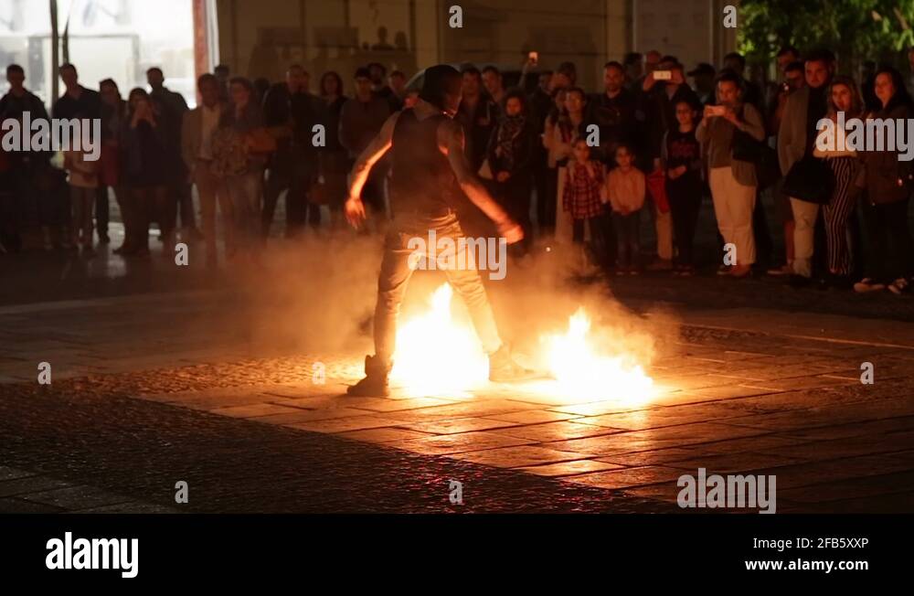 Fire spitter in front of a crowd of people in front of Notre Dame de ...