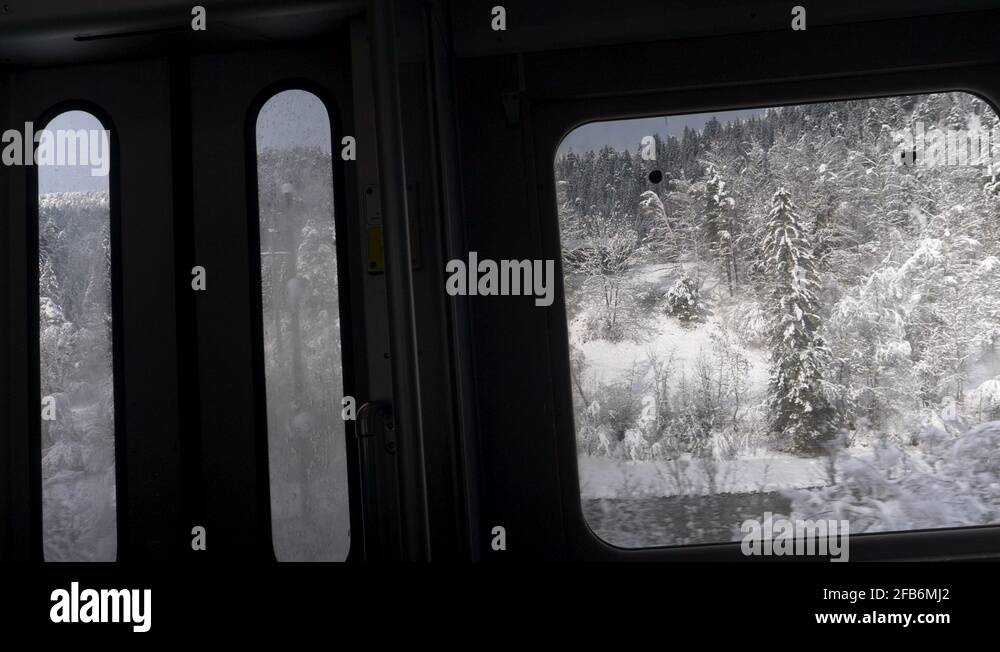 Travelling inside of a train carriage. Looking outside the window to ...