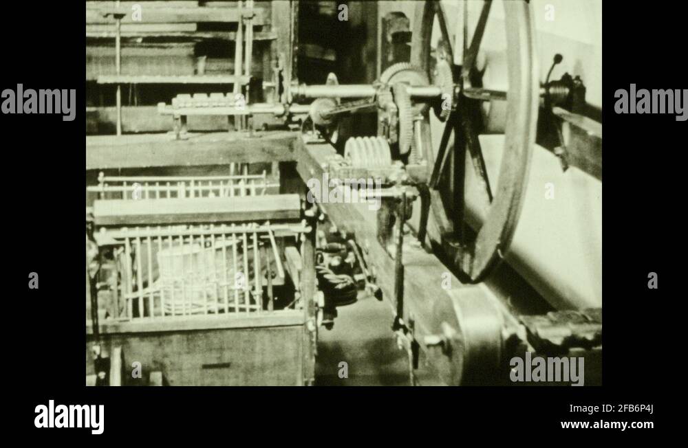 1940s: Spinning mule machine, hand pulls thread wrapped around spindle ...