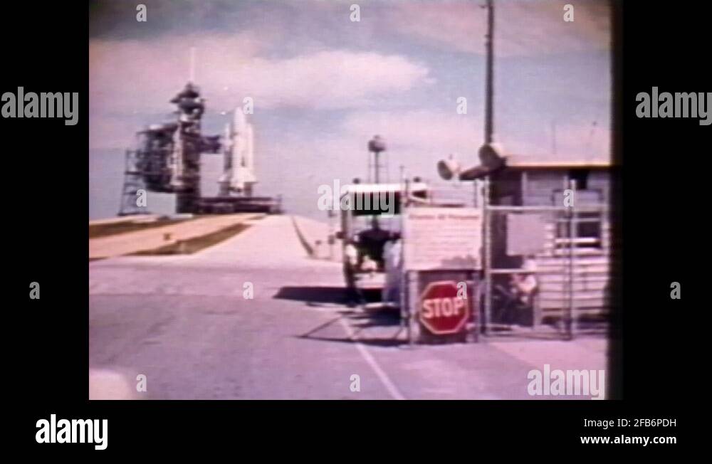 1980s: UNITED STATES: Stop sign by vehicle. Space craft on gantry ...