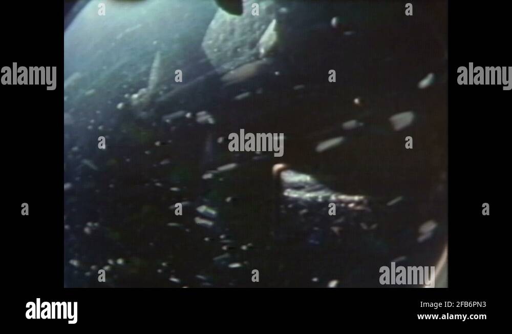1980s: Looking out rear end of space shuttle in space as ice crystals ...