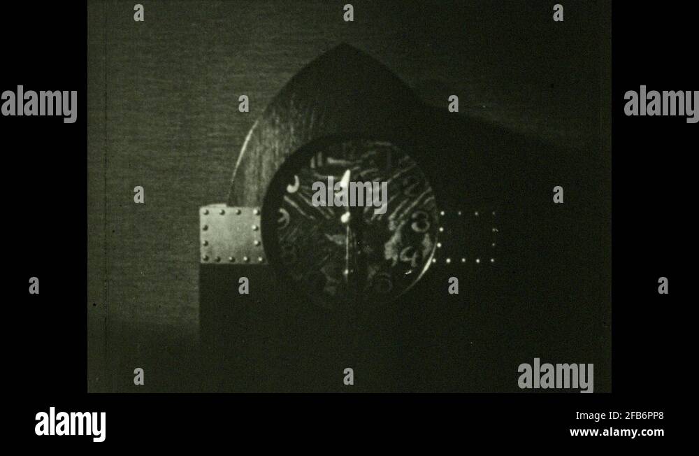 1950s: UNITED STATES: clock face by wall. Boy sits by telephone ...