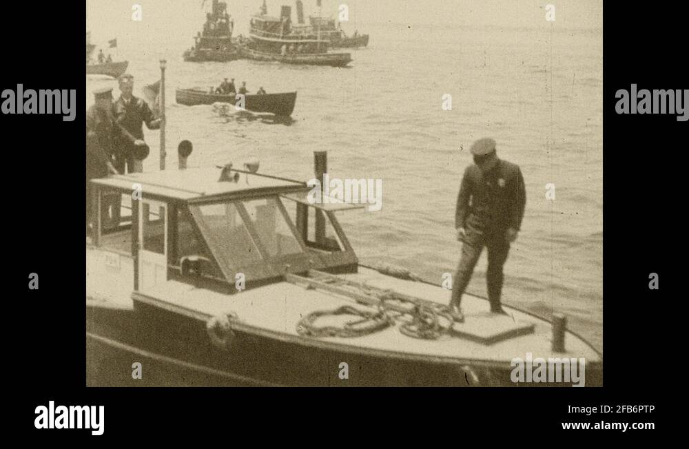 1920s: Small boat sails with many people aboard. Aerial view of the ...