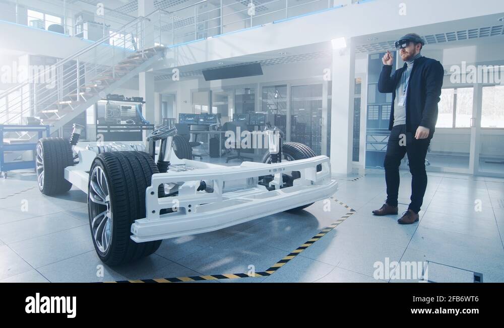 Automotive Engineer Working on Electric Car Chassis Platform, Using AR ...