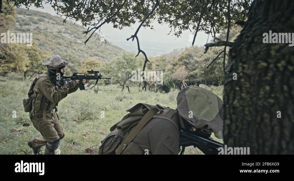 Squad of fully armed commando soldiers during combat in a forest ...