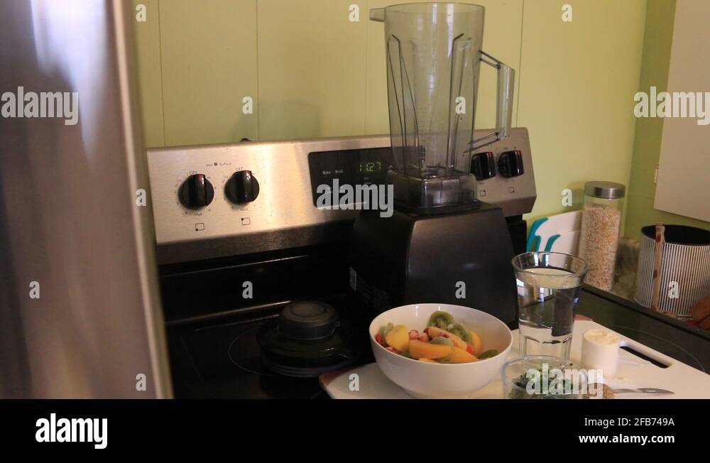 adding all of the ingredients into a blender for smoothie Stock Video ...