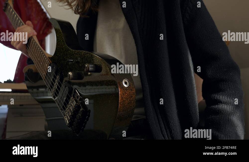 4K Young Musician Plugging Cable in Electric Guitar in Home Recording ...