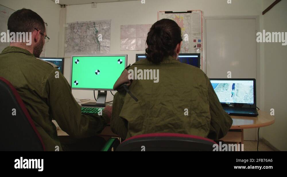 Israeli soldiers in a military command and control room looking at ...