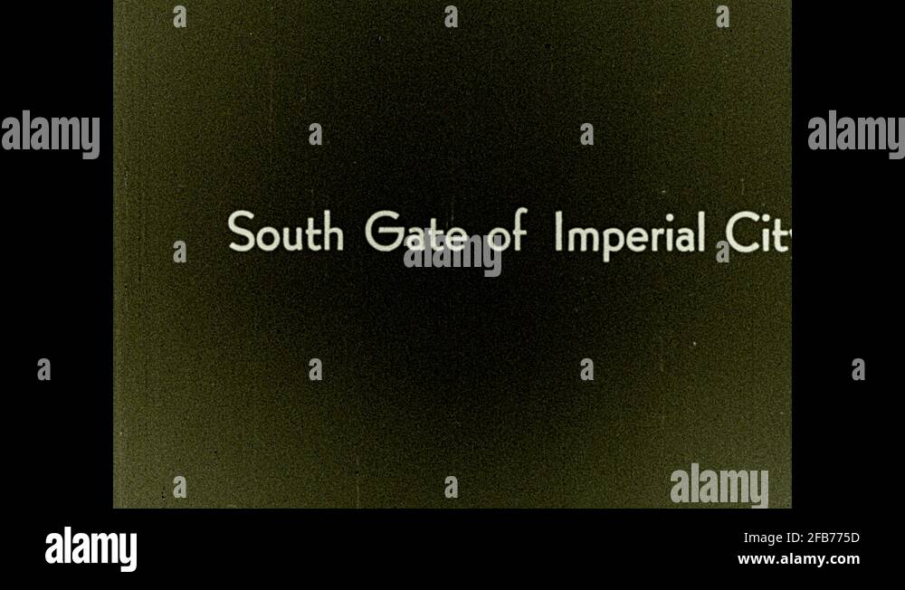 1930s: Intertitle card. People pull rickshaws through gateway ...