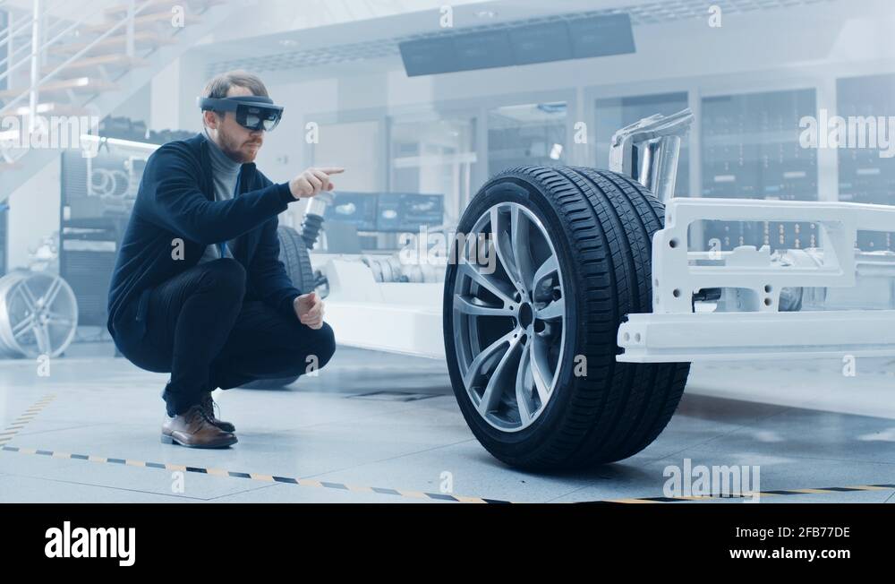 Automotive Engineer Working on Electric Car Chassis Platform, Using AR ...