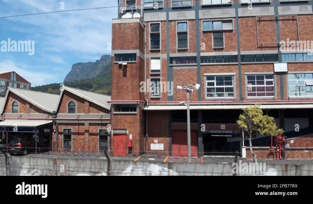 Mountain revealed behind building Stock Video Footage - Alamy