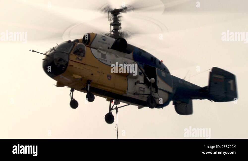 Ka-32 helicopter with a load at installation of metal structures of ...