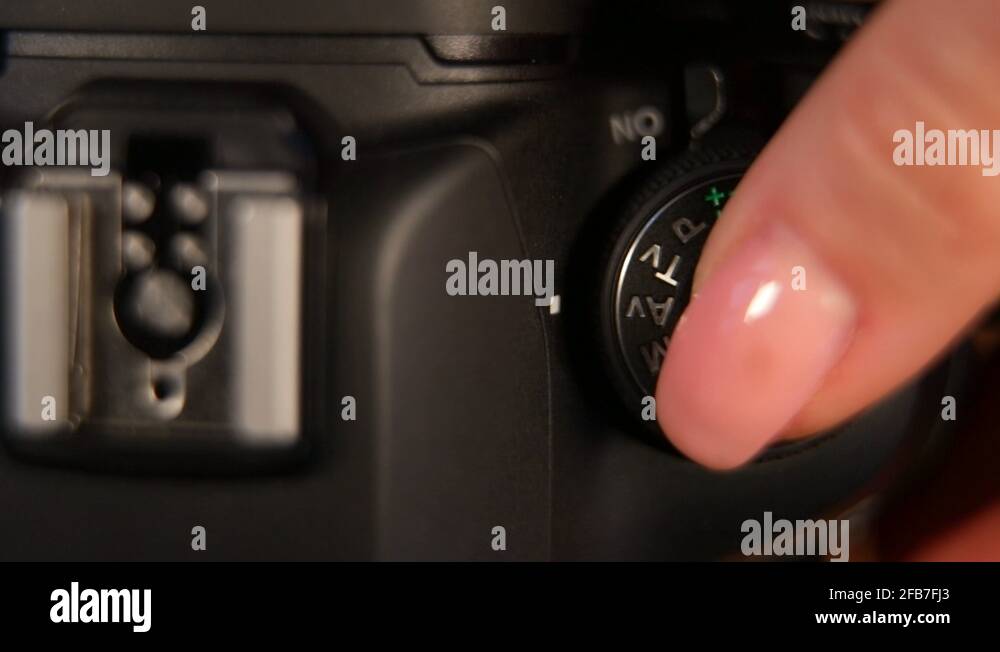 Womens hand turning on dslr camera. DSLR camera switches and buttons ...