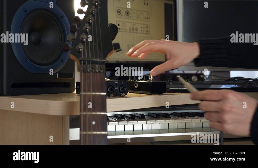 4K Young Musician Plugging Cable in Electric Guitar in Home Recording ...