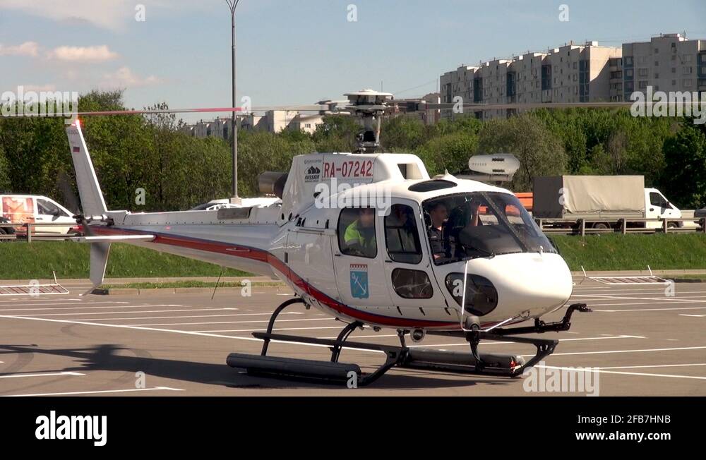 Helicopter Eurocopter AS350 with rotating main rotor blades in parking ...