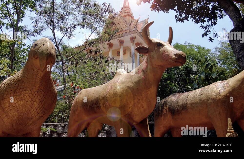 Golden magical animals guard Buddhist temple in forest in Asia (Left to ...