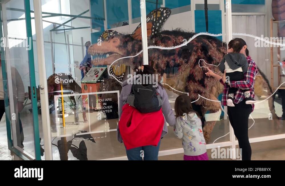 A large scaled T-Rex puppet roaring at children inside the Discovery ...