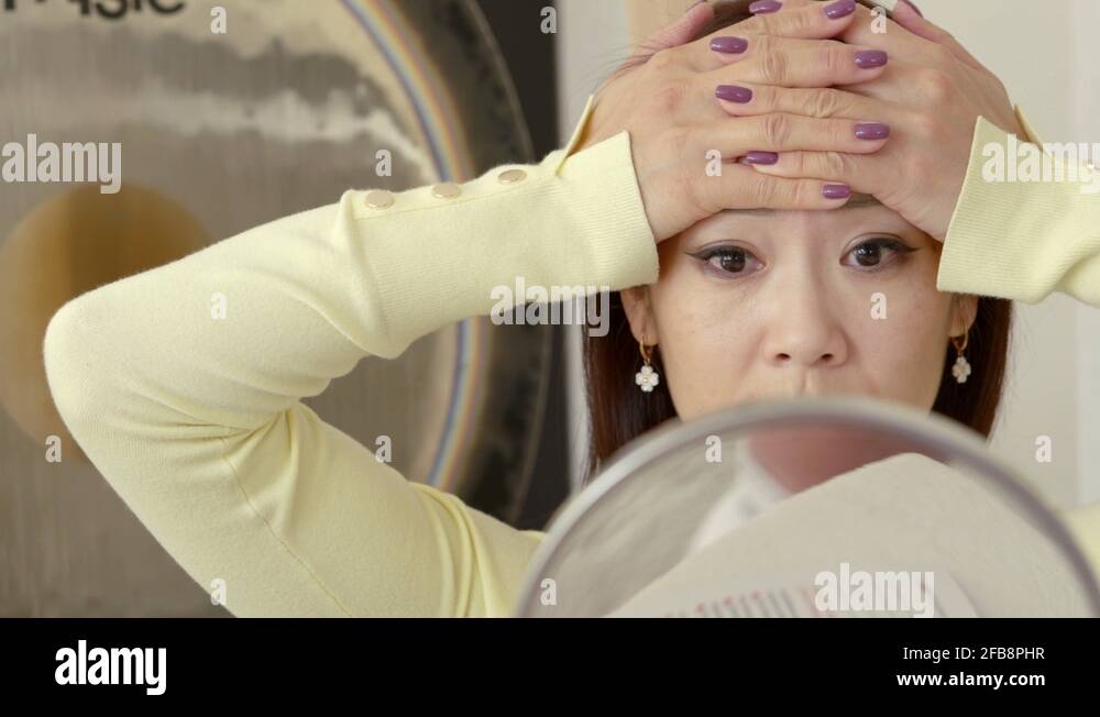 woman doing face fitness, facial aging. strengthening facial muscles ...