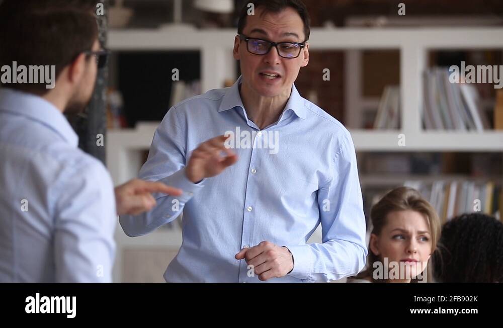 Two angry businessmen arguing having conflict confrontation at ...