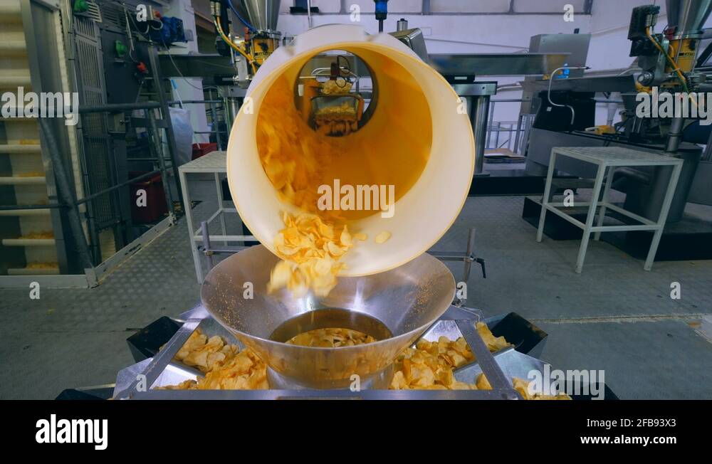 Crisps are pouring from an industrial mechanism Stock Video Footage - Alamy