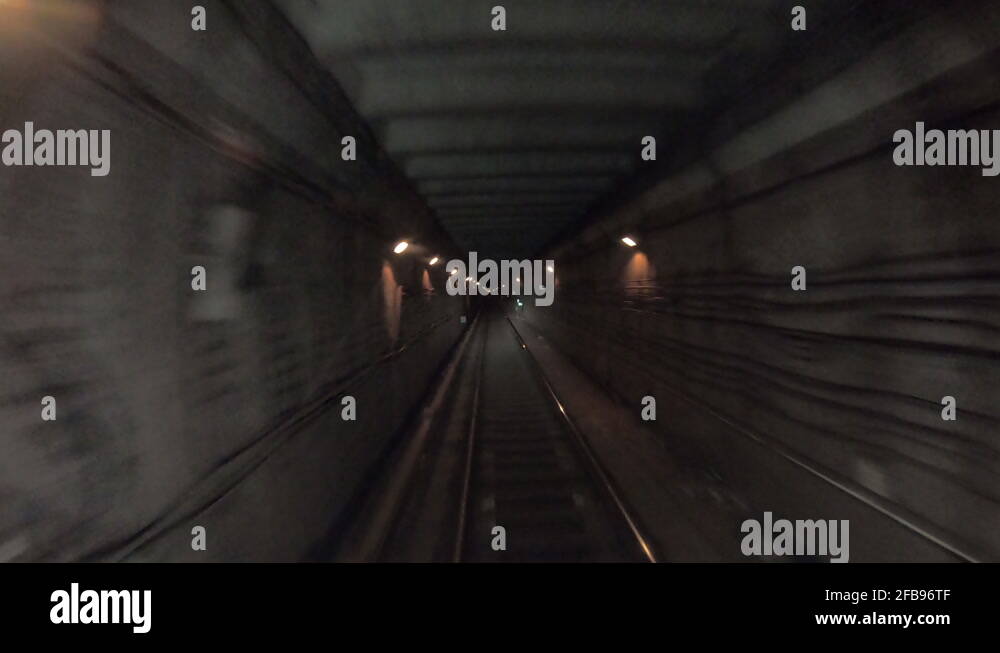 Fast speed underground train riding in a tunnel of the modern city ...