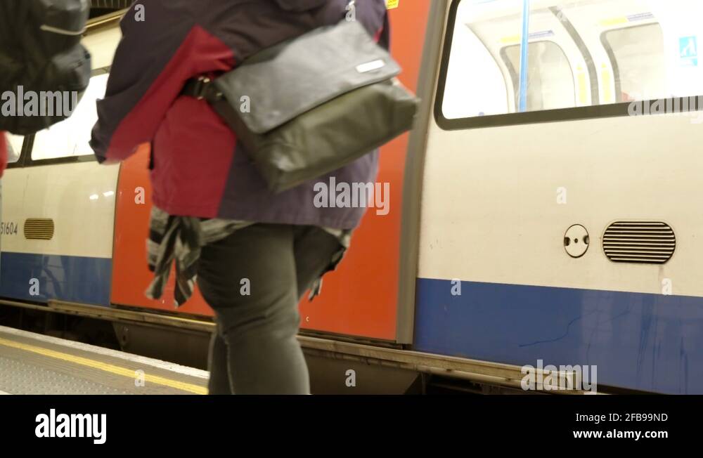 People looking what fell on to a Tube track moments after a train left ...