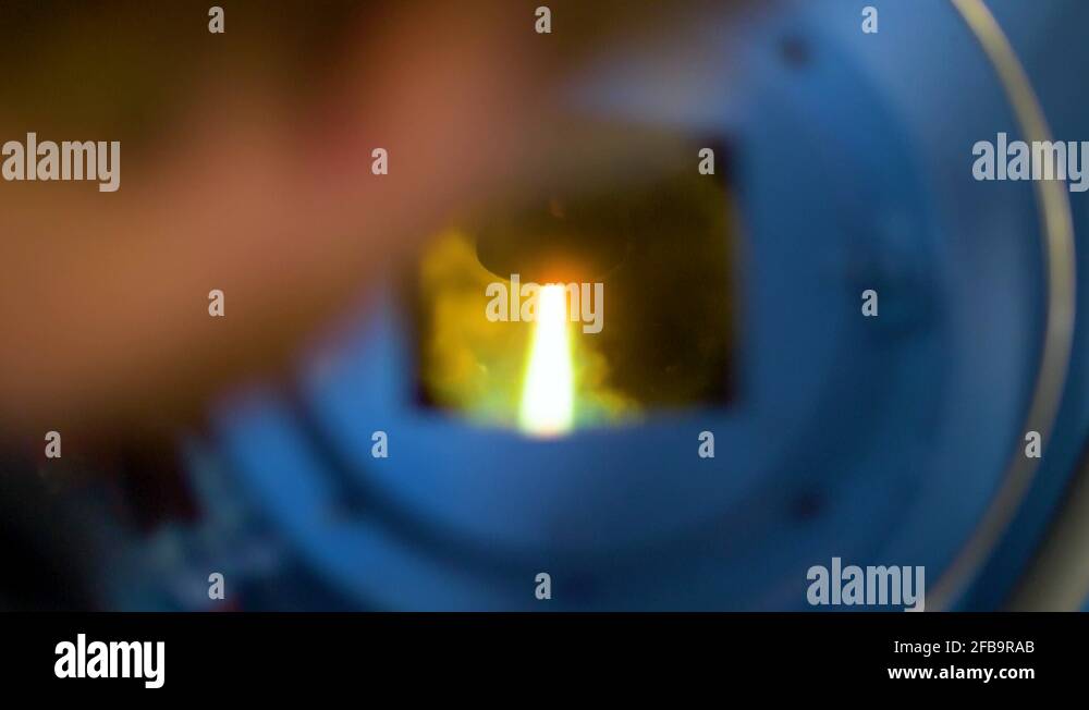 Man watching through the window of plasma arc furnace melting metal ...